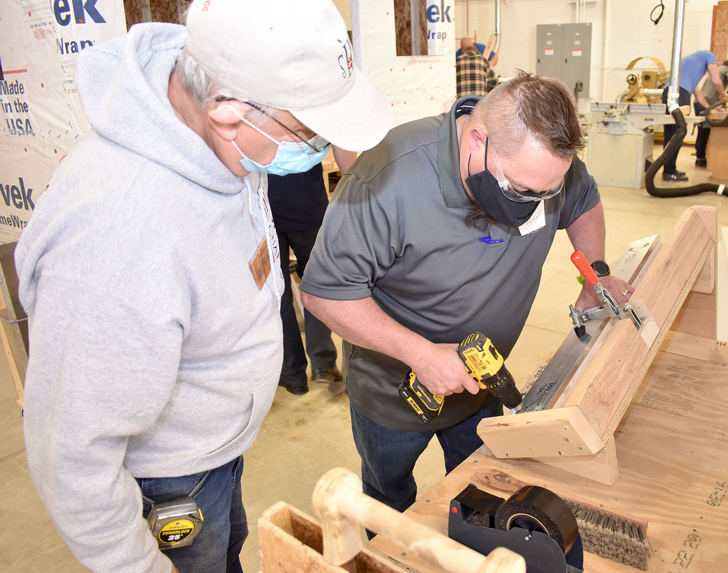 Employees volunteer time to make beds for local children